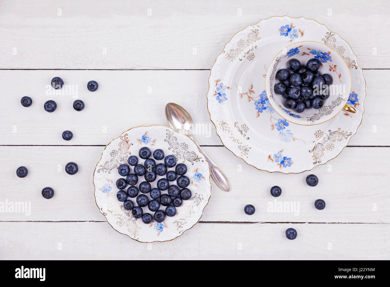 Collectors cupand plate of blueberries Stock Photo - Alamy