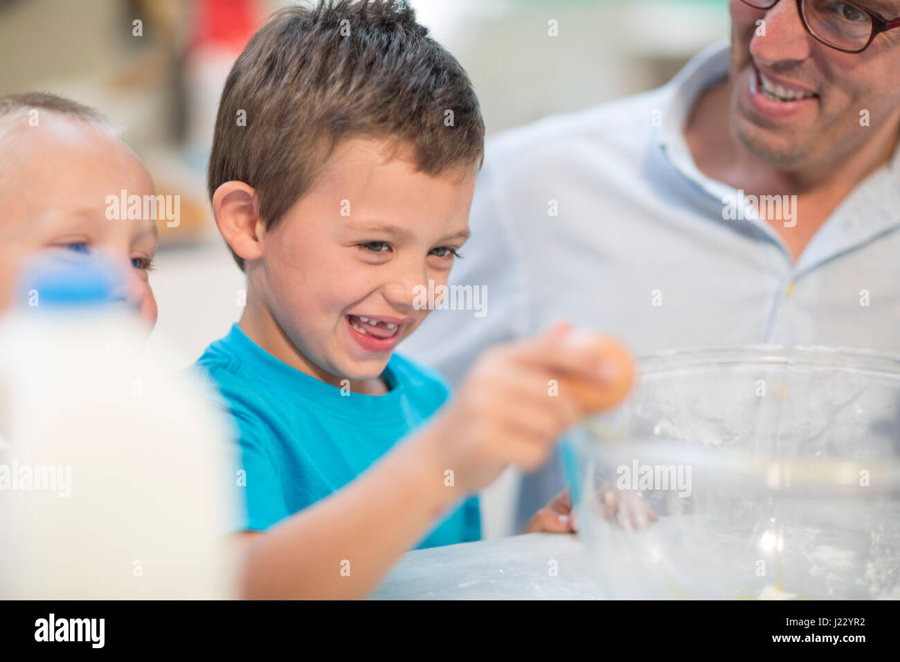 Son helping father cook hi-res stock photography and images - Alamy
