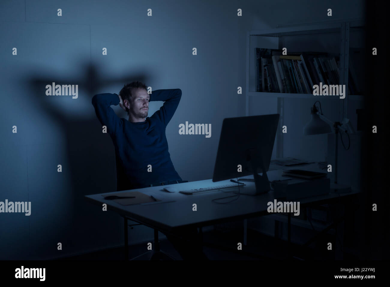 Man working late in office Stock Photo - Alamy