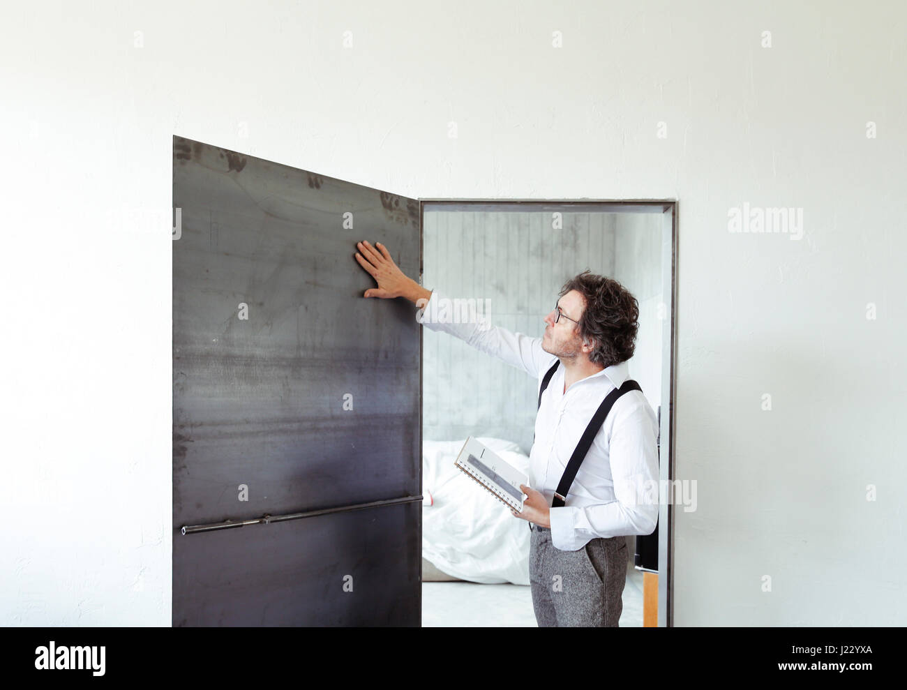 Architect checking steel door at construction site Stock Photo - Alamy
