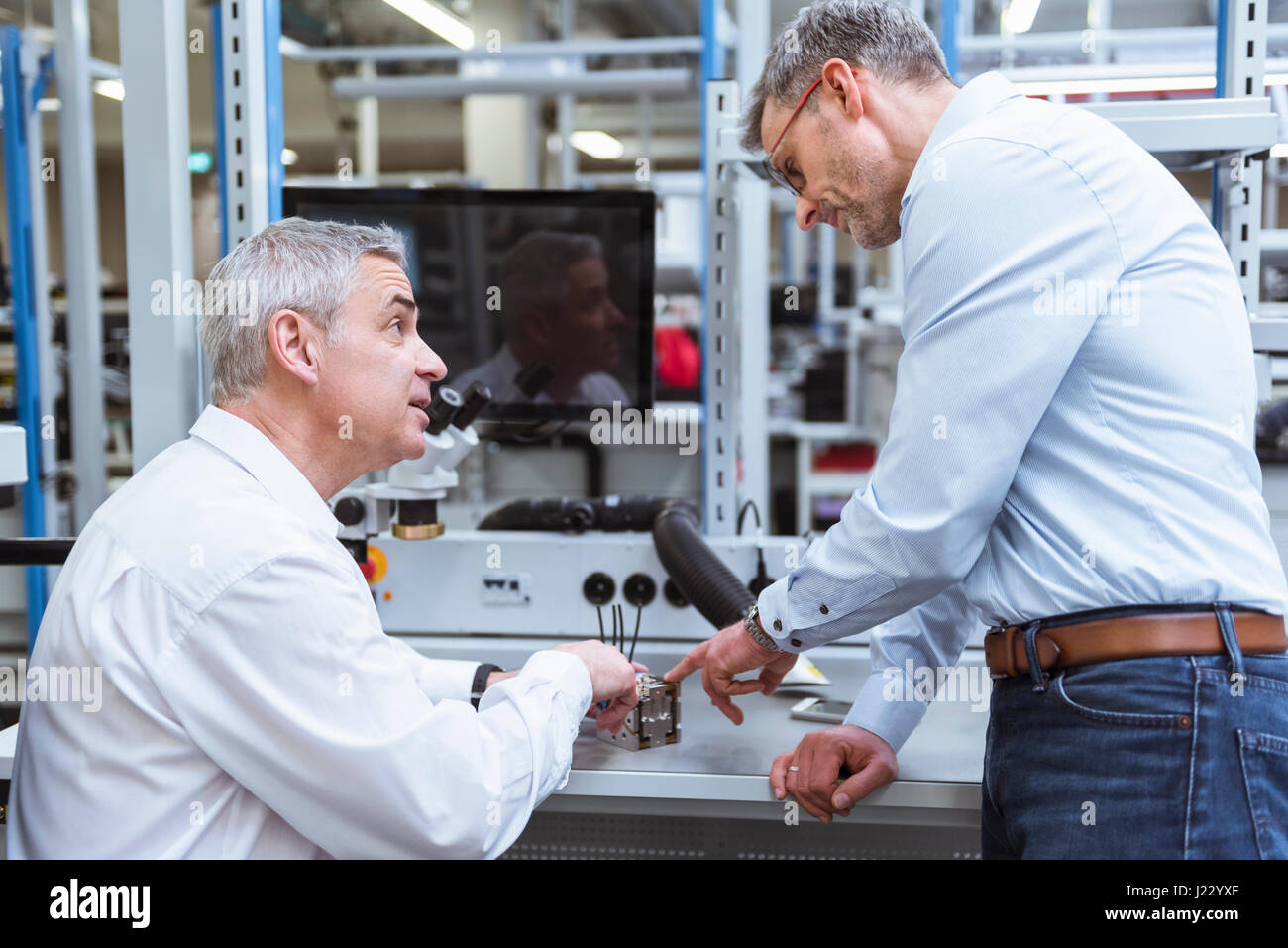 Two managers discussing product in company Stock Photo - Alamy