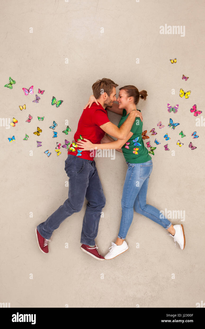 Young couple kissing amidst butterflies Stock Photo - Alamy