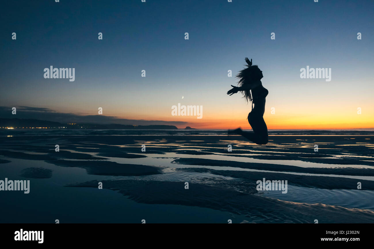 Female silhouette arms outstretched jumping hi-res stock photography ...