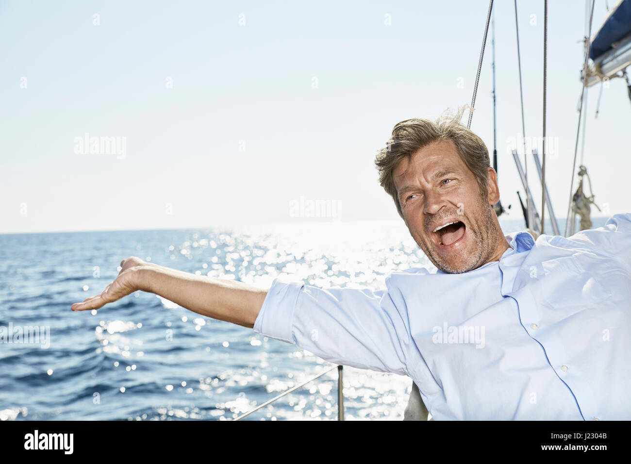 Portrait of screaming man on his sailing boat Stock Photo - Alamy