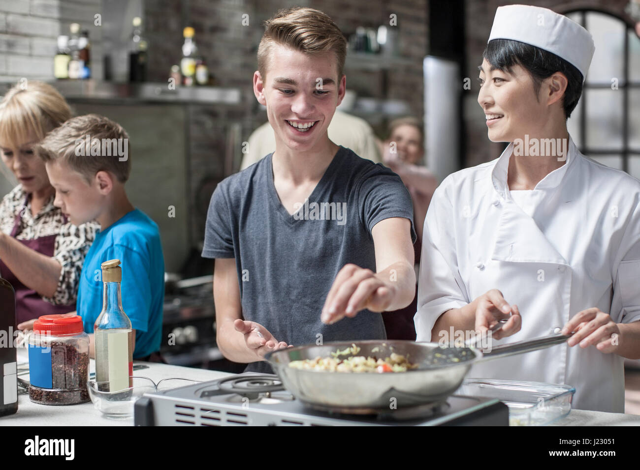 Teenager and female chef cooking together Stock Photo - Alamy