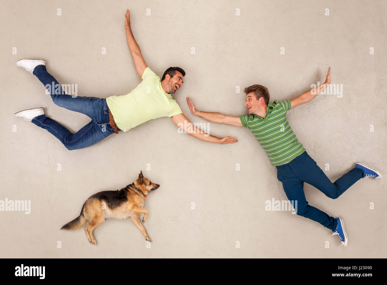 Friends flying over dog Stock Photo - Alamy