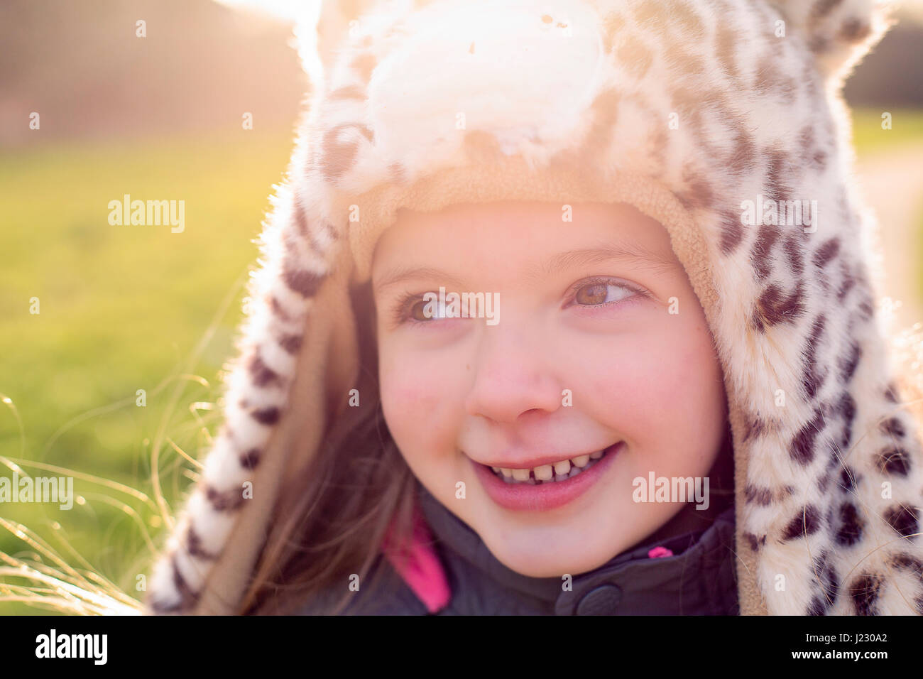 Portrait of shy little girl wearing hat with leopard print Stock Photo ...