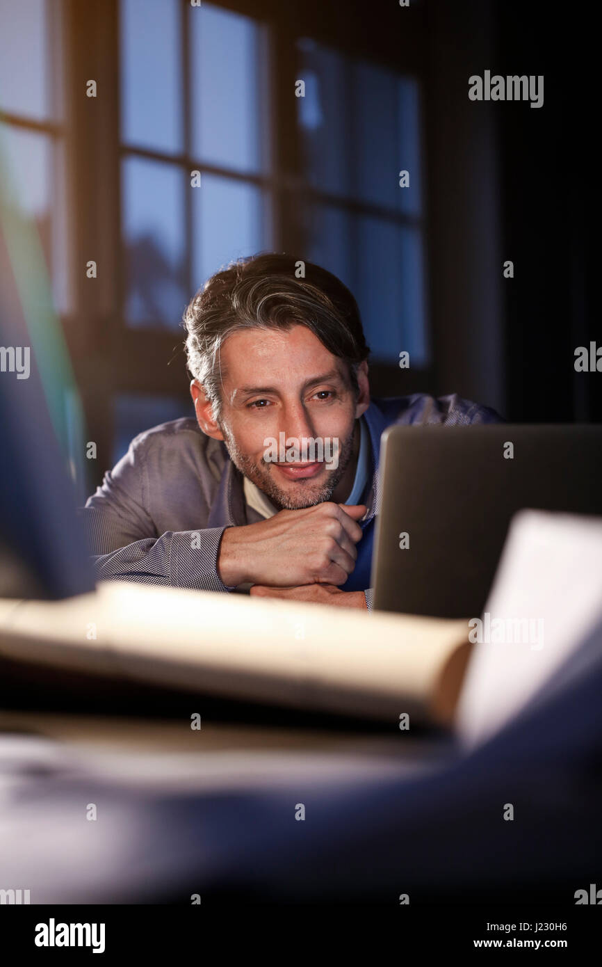 Man working late in office Stock Photo - Alamy