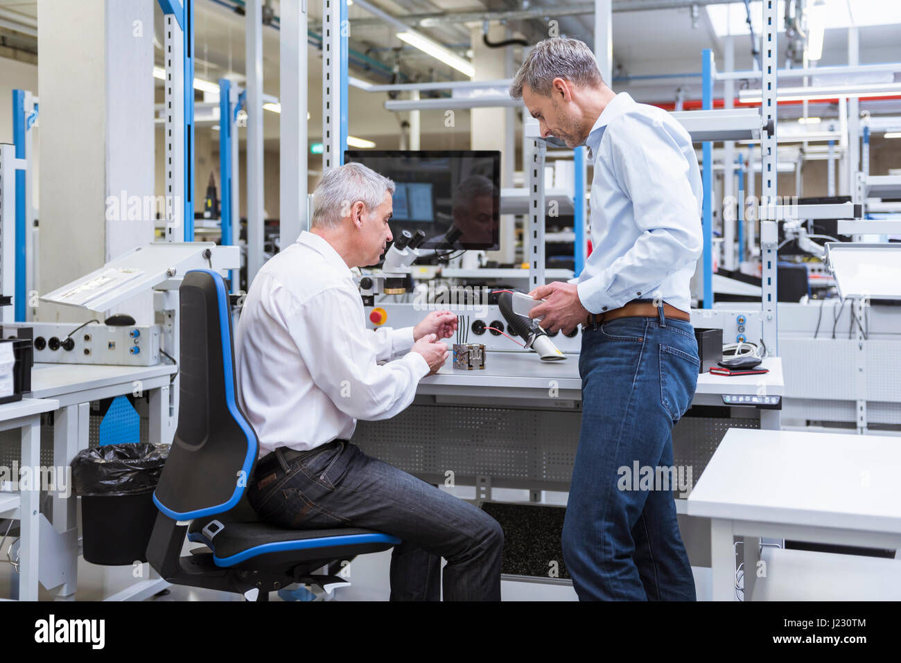 Two managers discussing product in company Stock Photo - Alamy