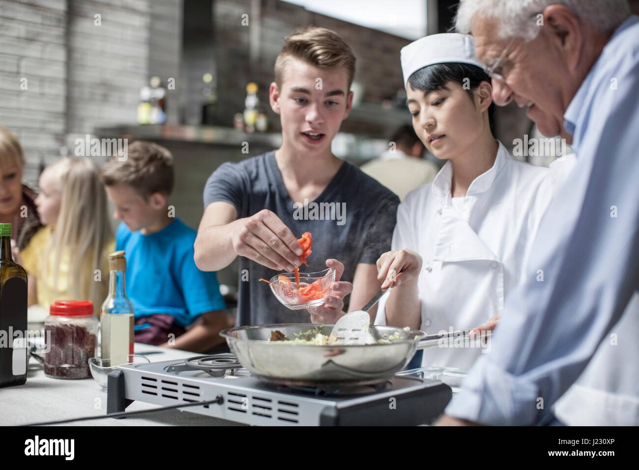 Female chef and students cooking in cooking class Stock Photo - Alamy