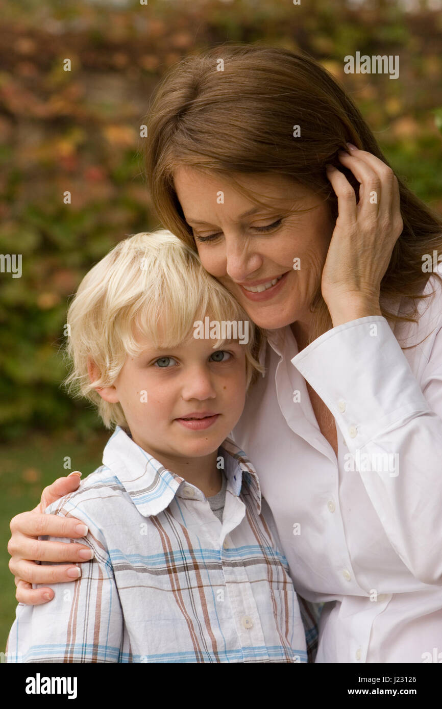 Happy mother hugging her son outside Stock Photo - Alamy