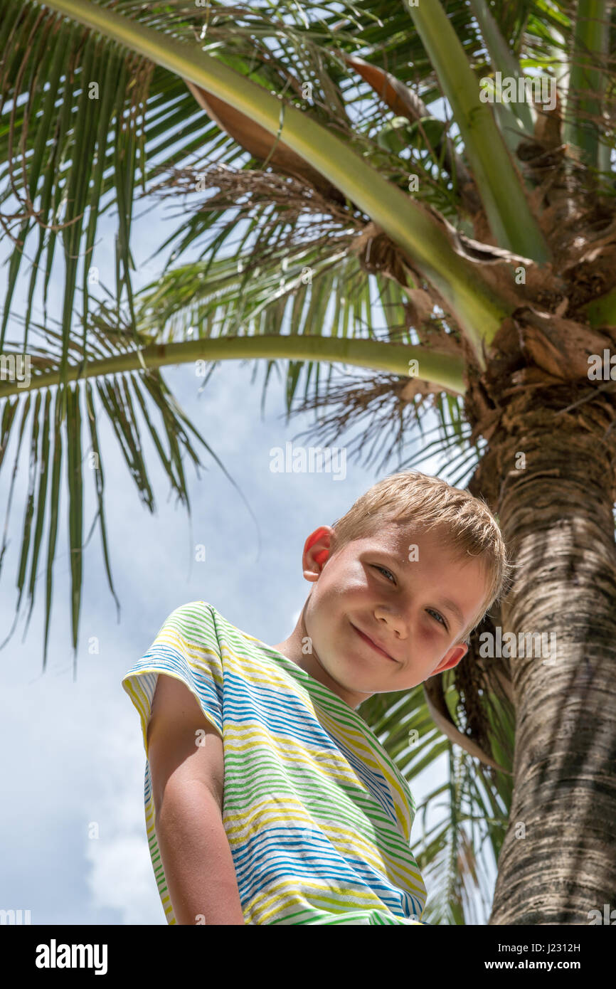 happy boy sitting on palm Stock Photo - Alamy