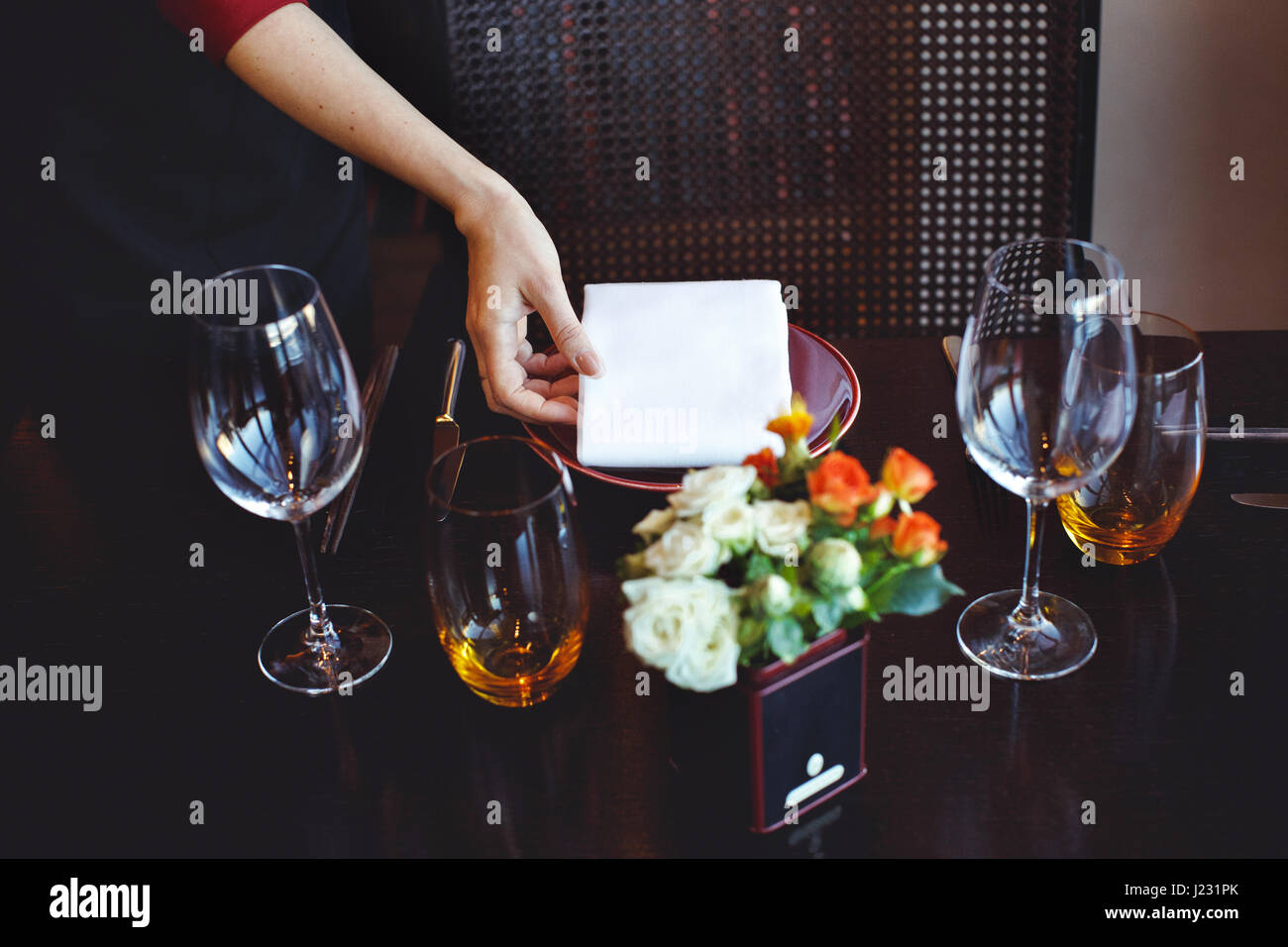 Waiter serving table in restaurant Stock Photo - Alamy