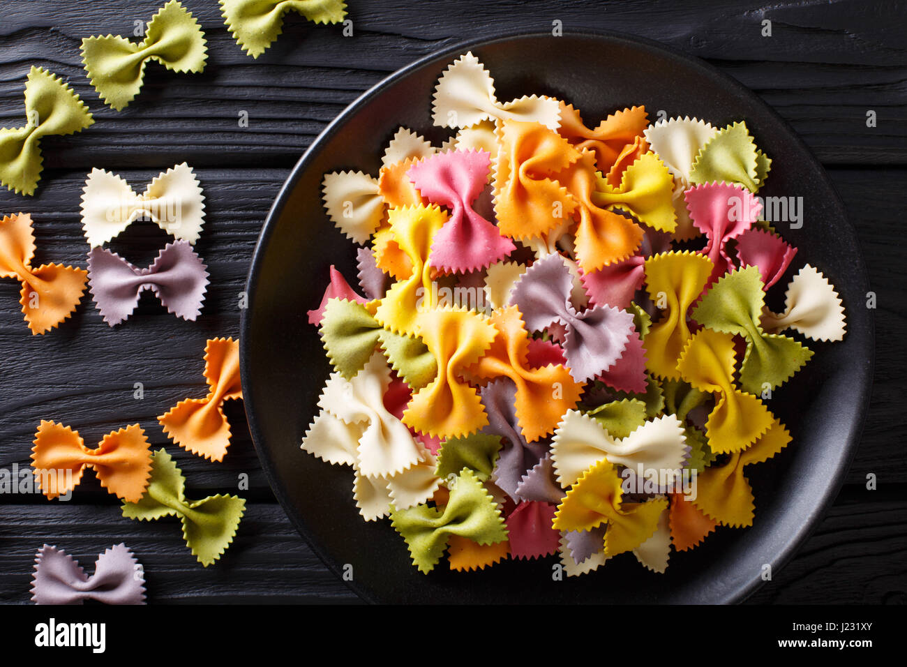 Italian raw multicolored farfalle pasta close-up on the table ...