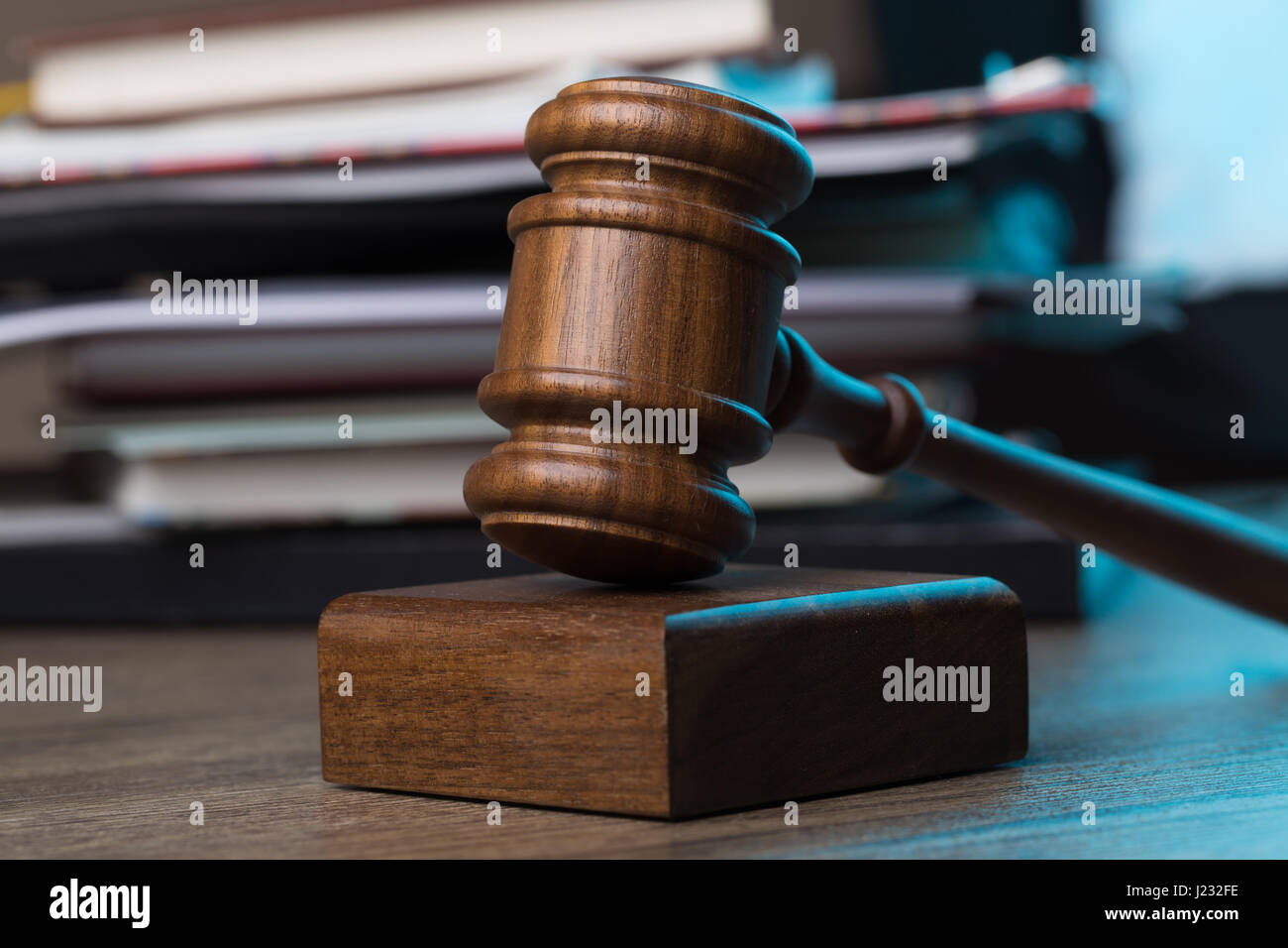 Wooden table with hammer, documents Stock Photo - Alamy