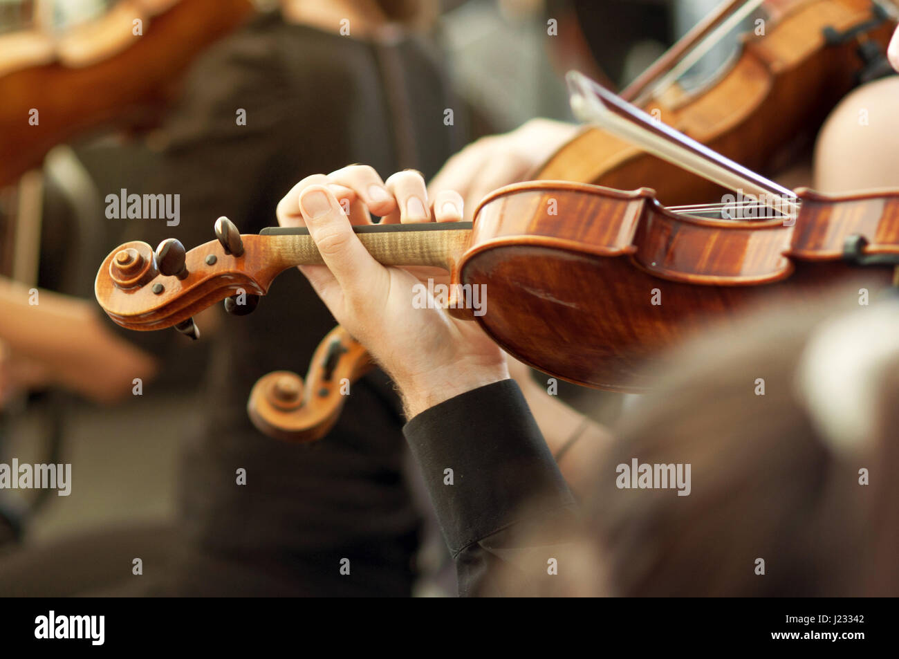 Member of classical music orchestra playing violin on a concert ...
