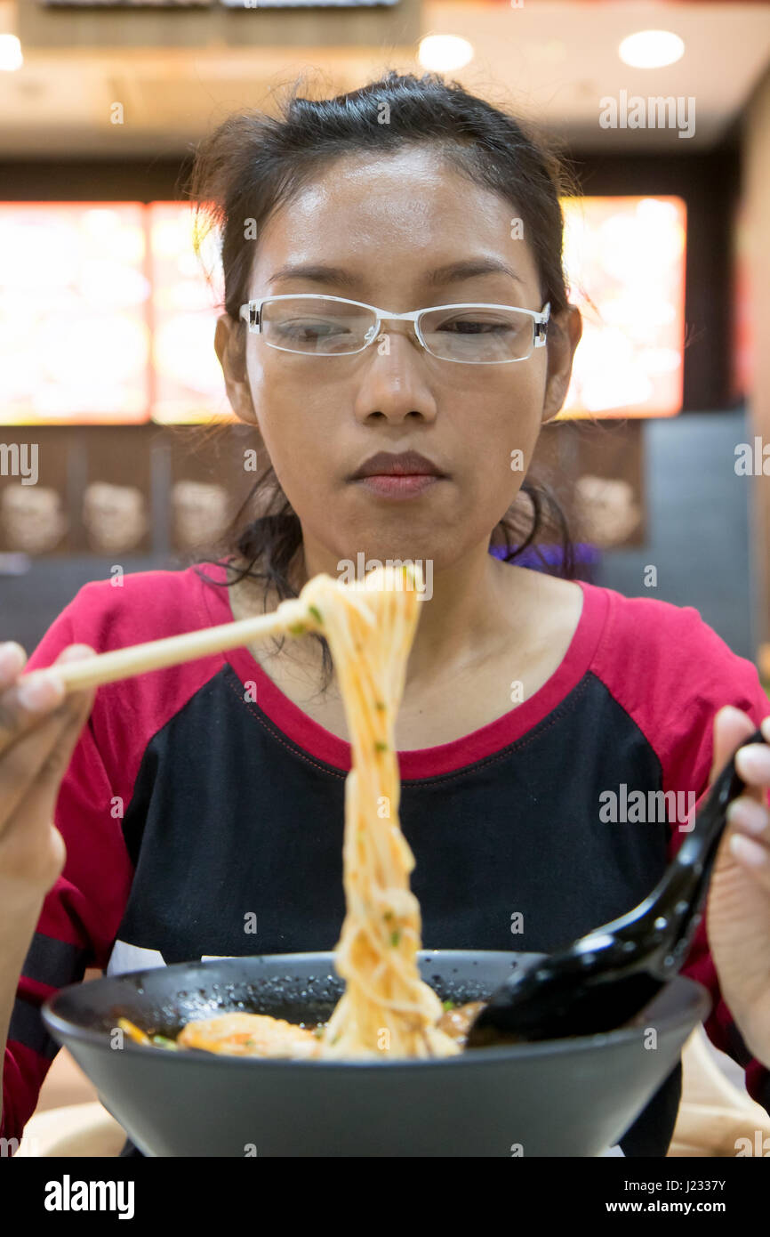 Chinese woman eating noodles in hi-res stock photography and images - Alamy