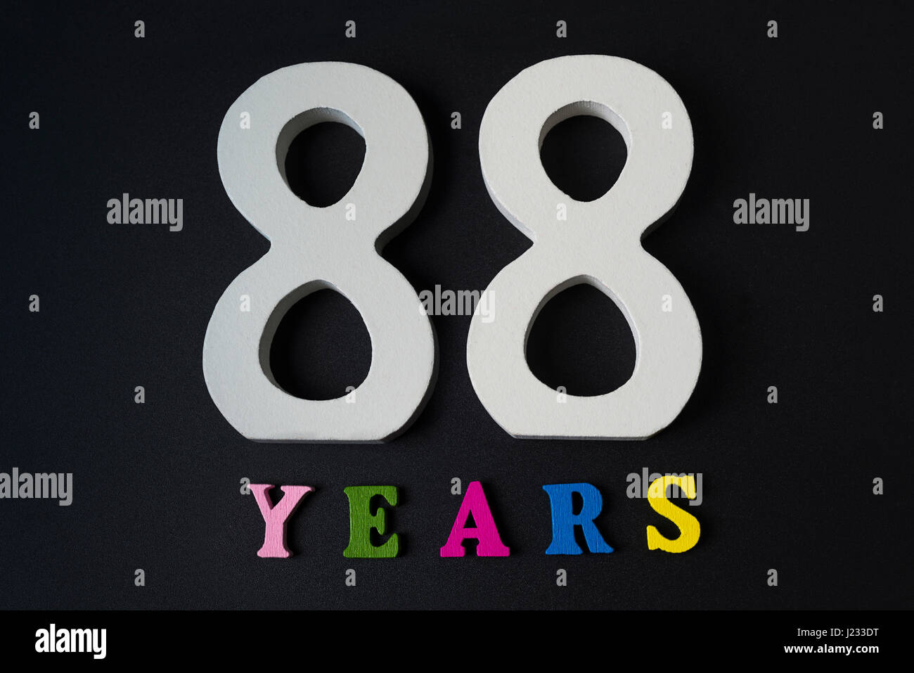 Letters and numbers eighty-eight years old on a black isolated ...
