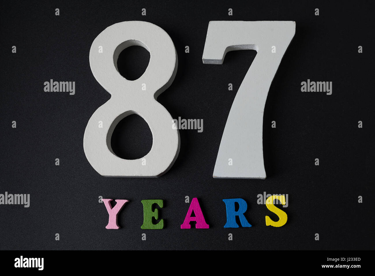 Letters and numbers eighty-seven years old on a black isolated ...