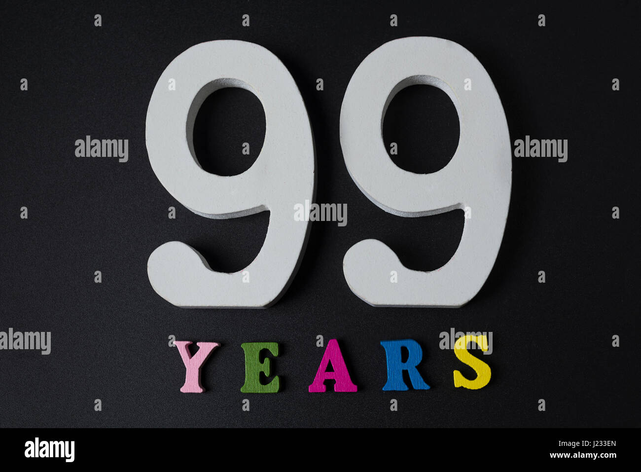 Letters and numbers ninety-nine years on a black isolated background ...