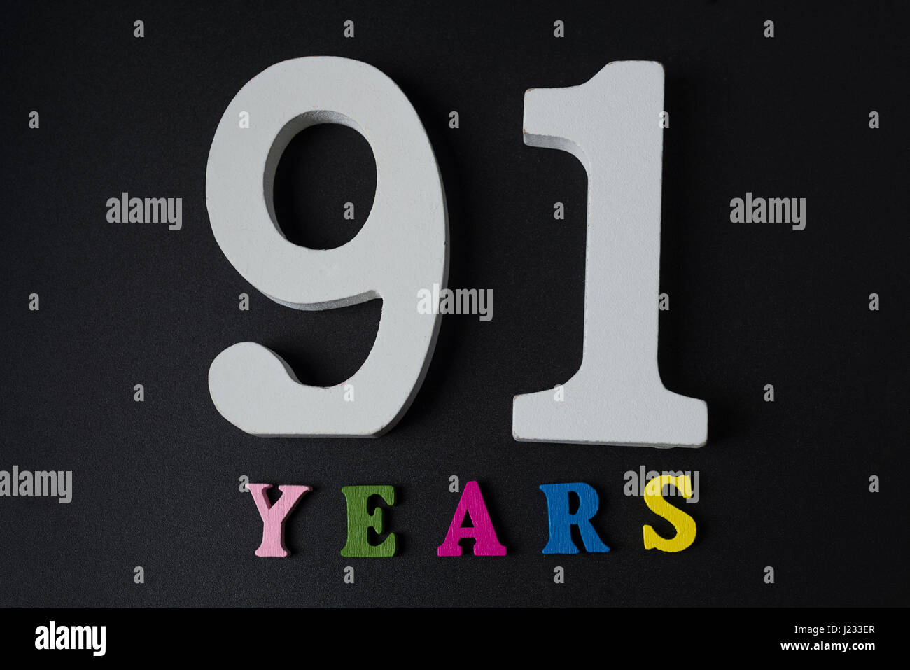 Letters and numbers ninety-one year on black isolated background Stock ...
