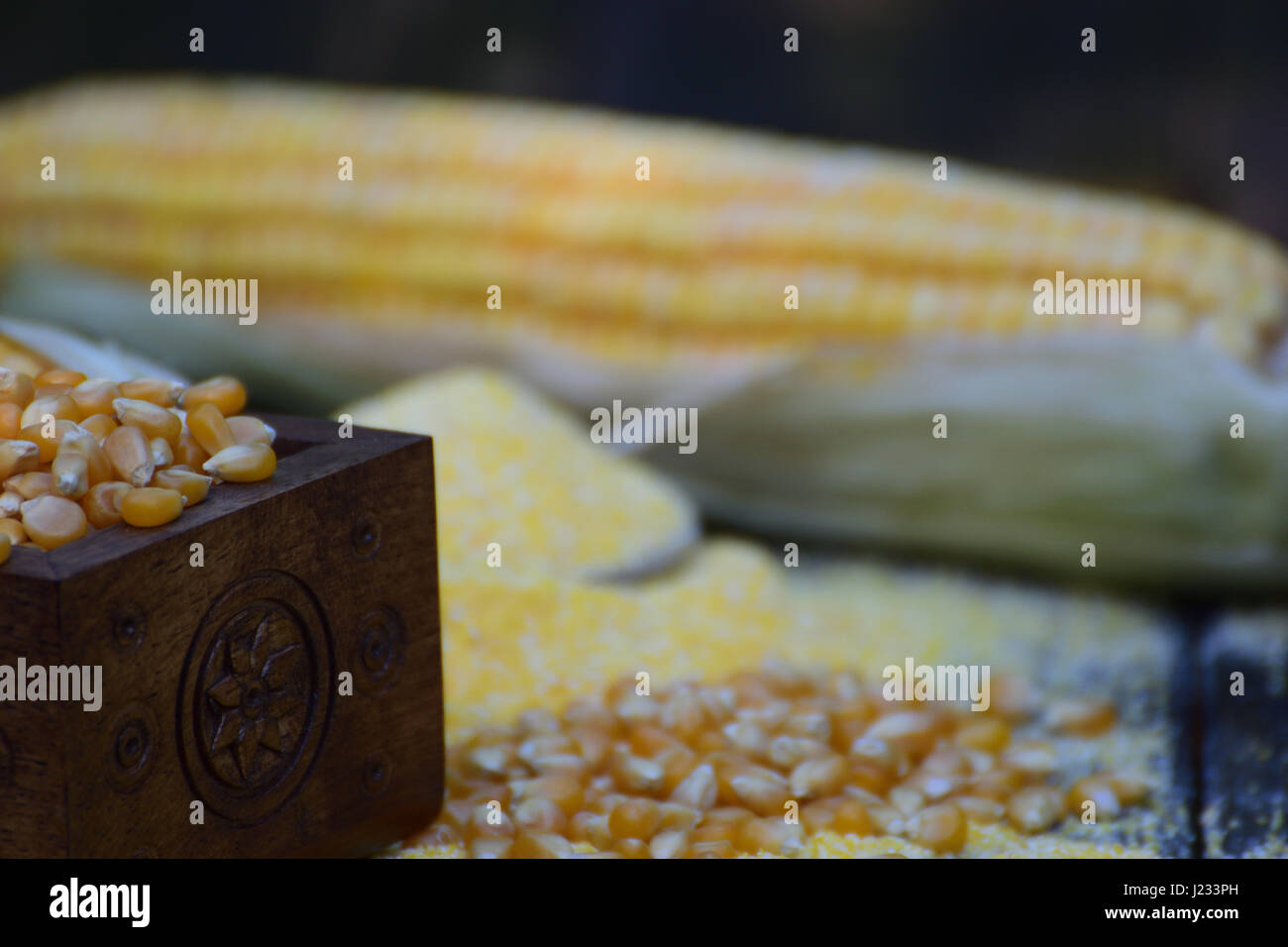 Close-up shoot of handmade embossed chest full of corn grains; bokeh of ...