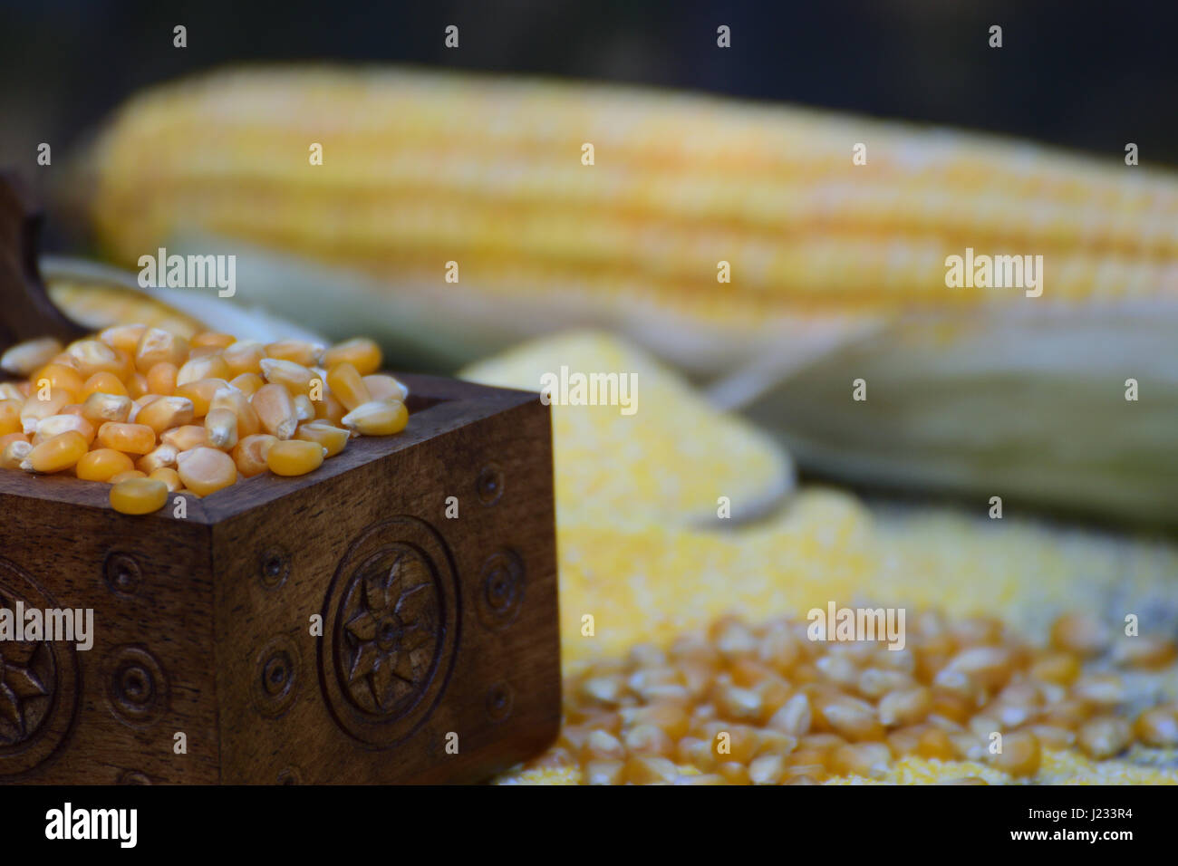Close-up shoot of handmade embossed chest full of corn grains; bokeh of ...