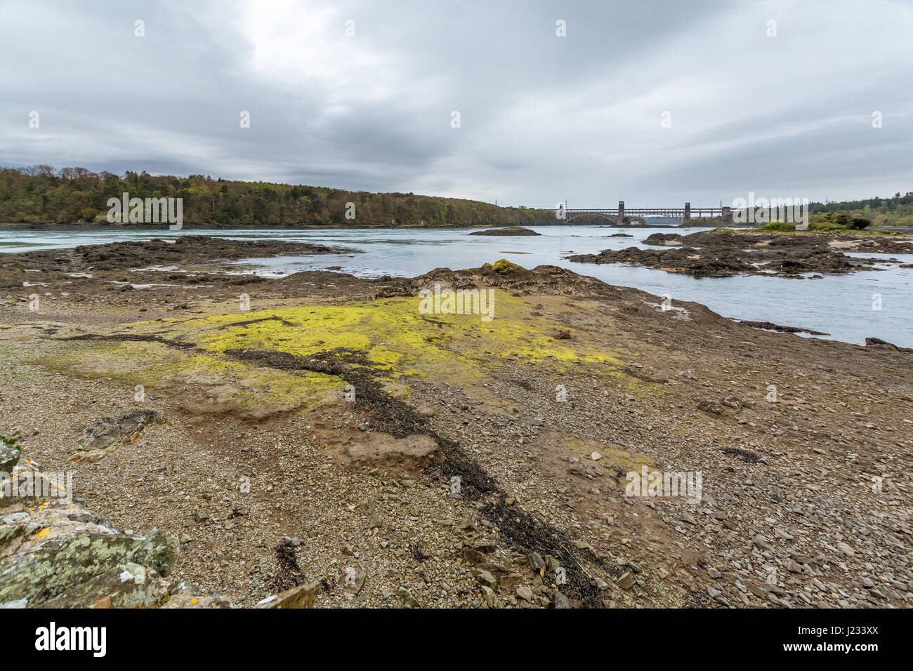 A view along the Menai Strait from Anglesey, with Britannia Bridge in ...