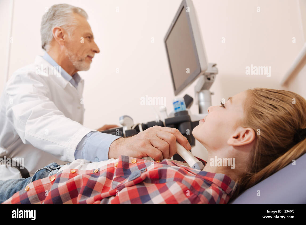 Handsome practitioner using ultrasound transducer in the hospital Stock ...