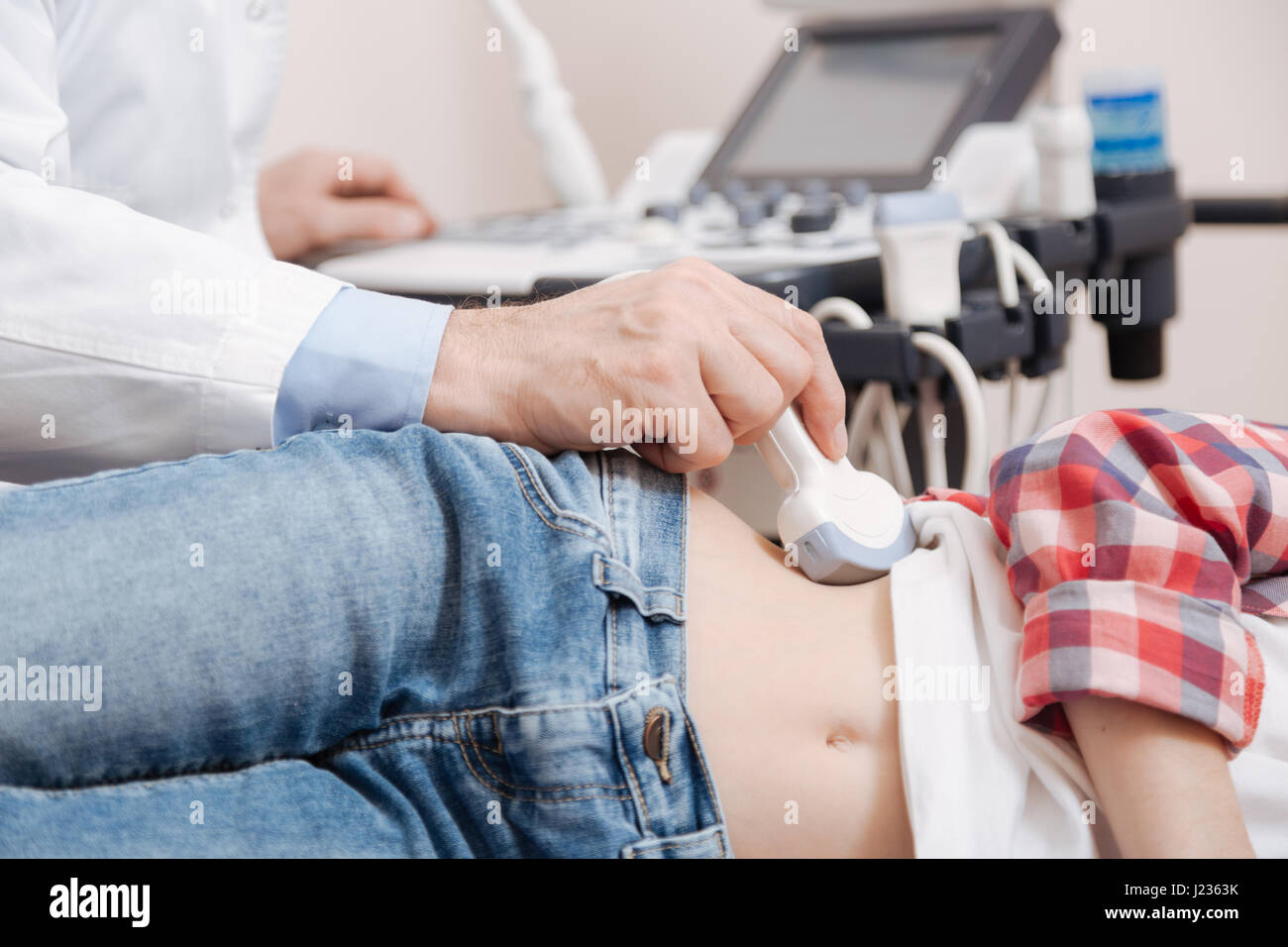 Senior practitioner using ultrasound hi-res stock photography and ...