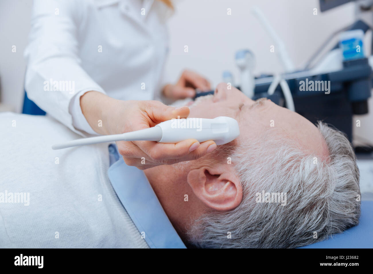 Caring Medical Specialist Providing Head Ultrasound In The Hospital caring-medical-specialist-providing-head-ultrasound-in-the-hospital