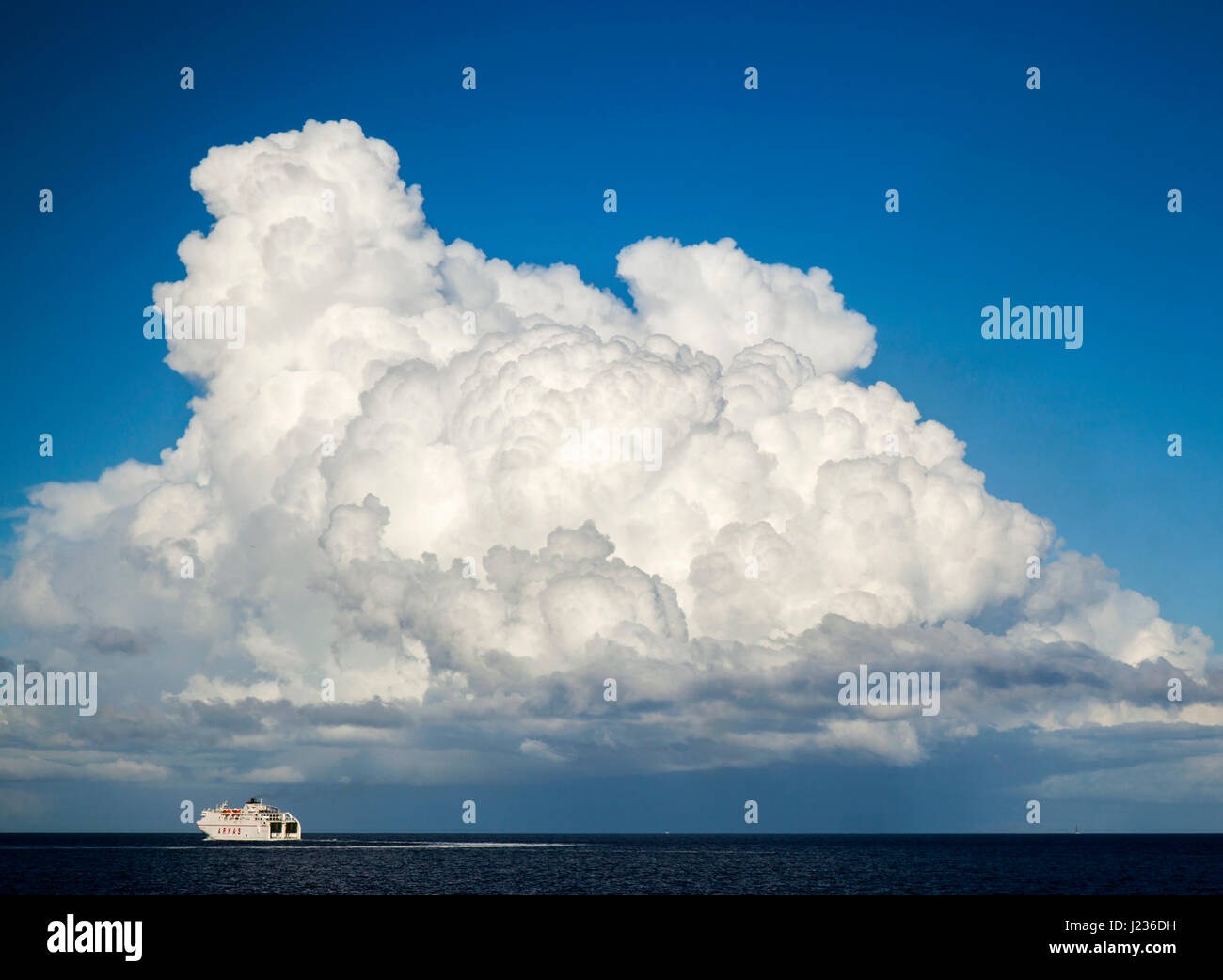 beautiful cumulus cloud over ocean, sea ferry on horizon, weather and ...