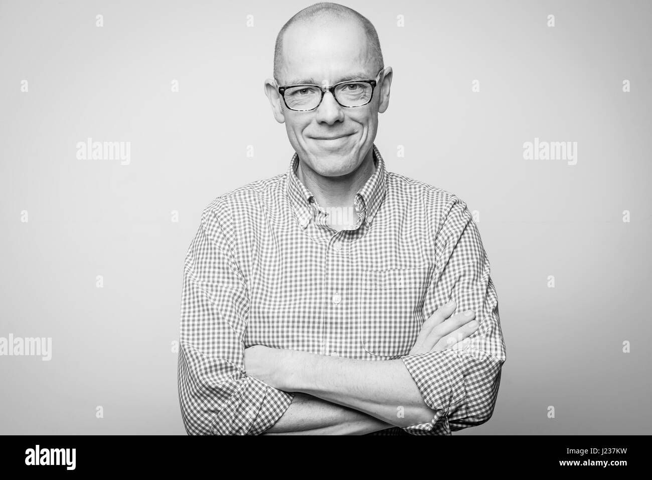 Smiling man in front of grey background Stock Photo - Alamy
