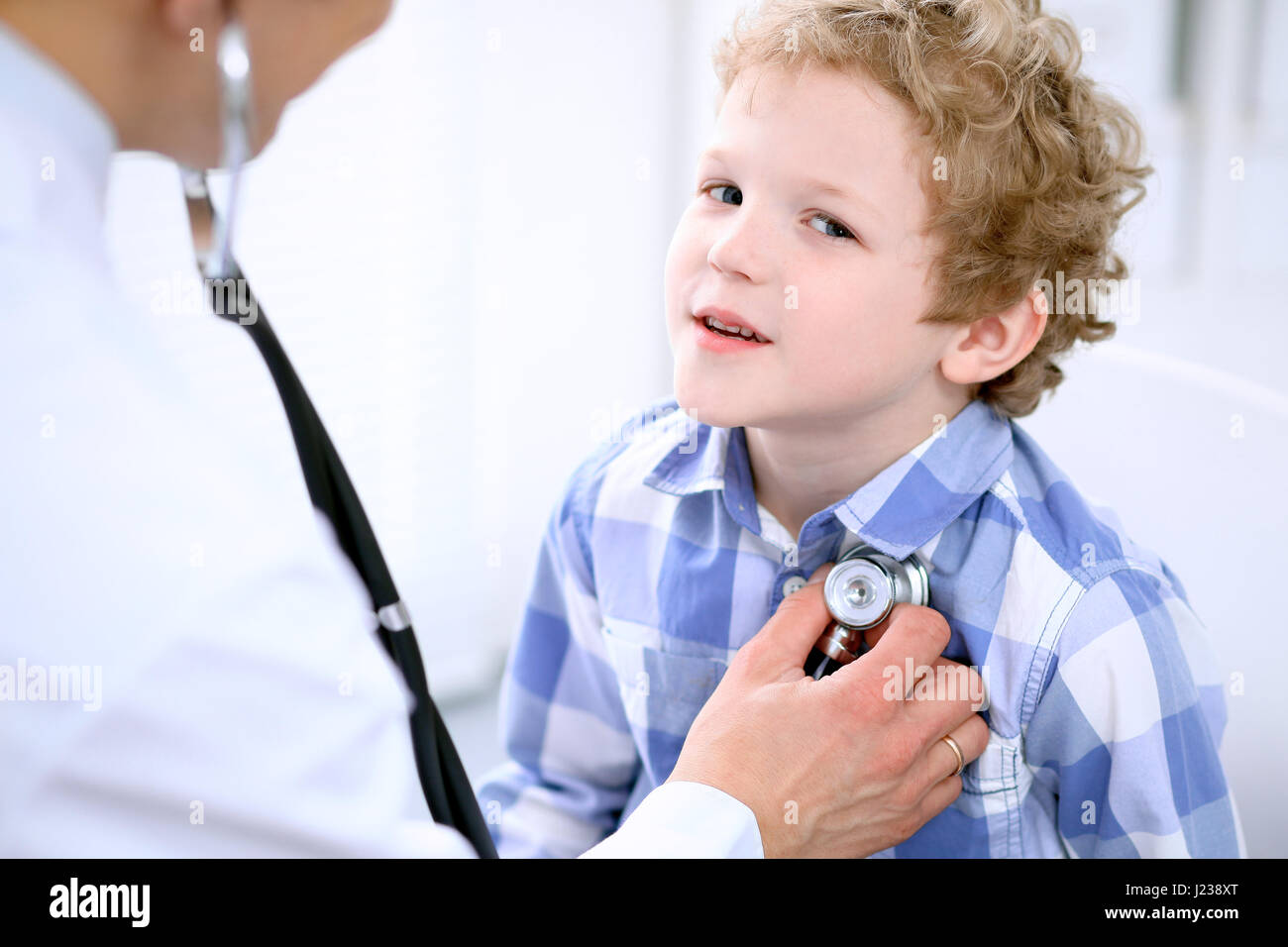 Doctor examining a child patient by stethoscope Stock Photo - Alamy