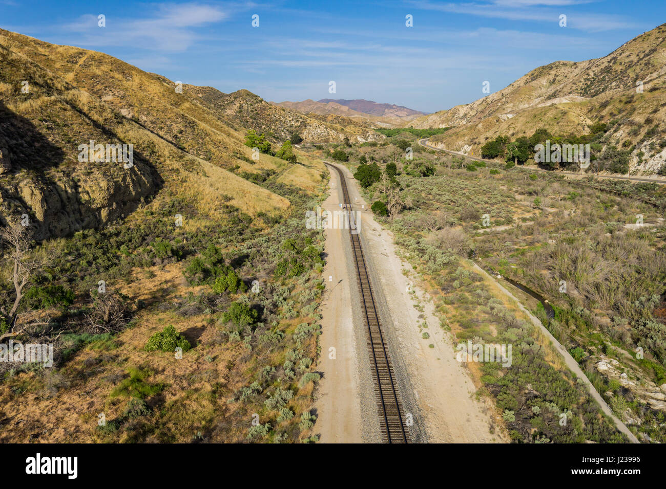 Straight long California desert railroad through a vally in the ...