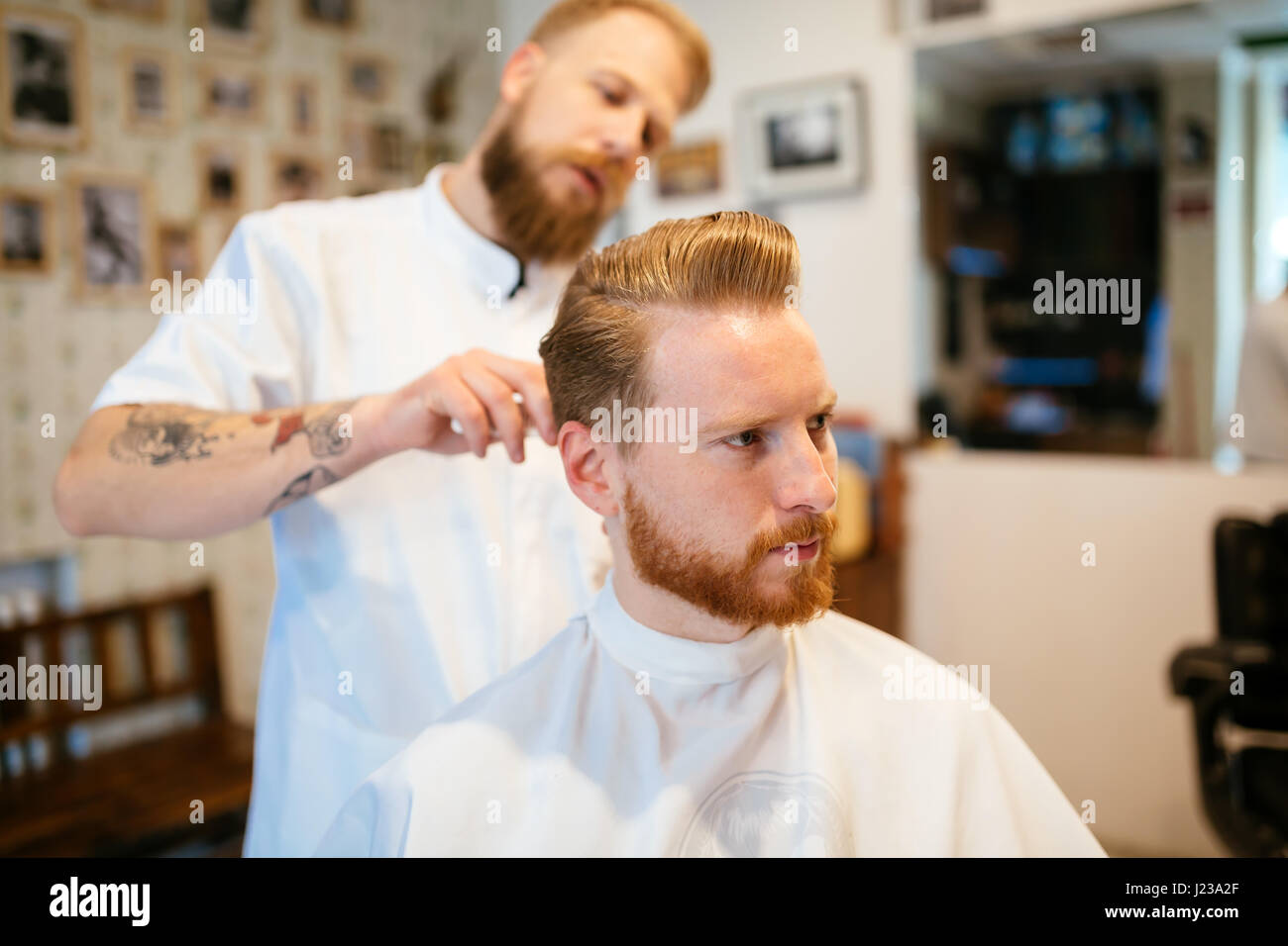 Male receiving hair beard treatment in barber shop Stock Photo - Alamy