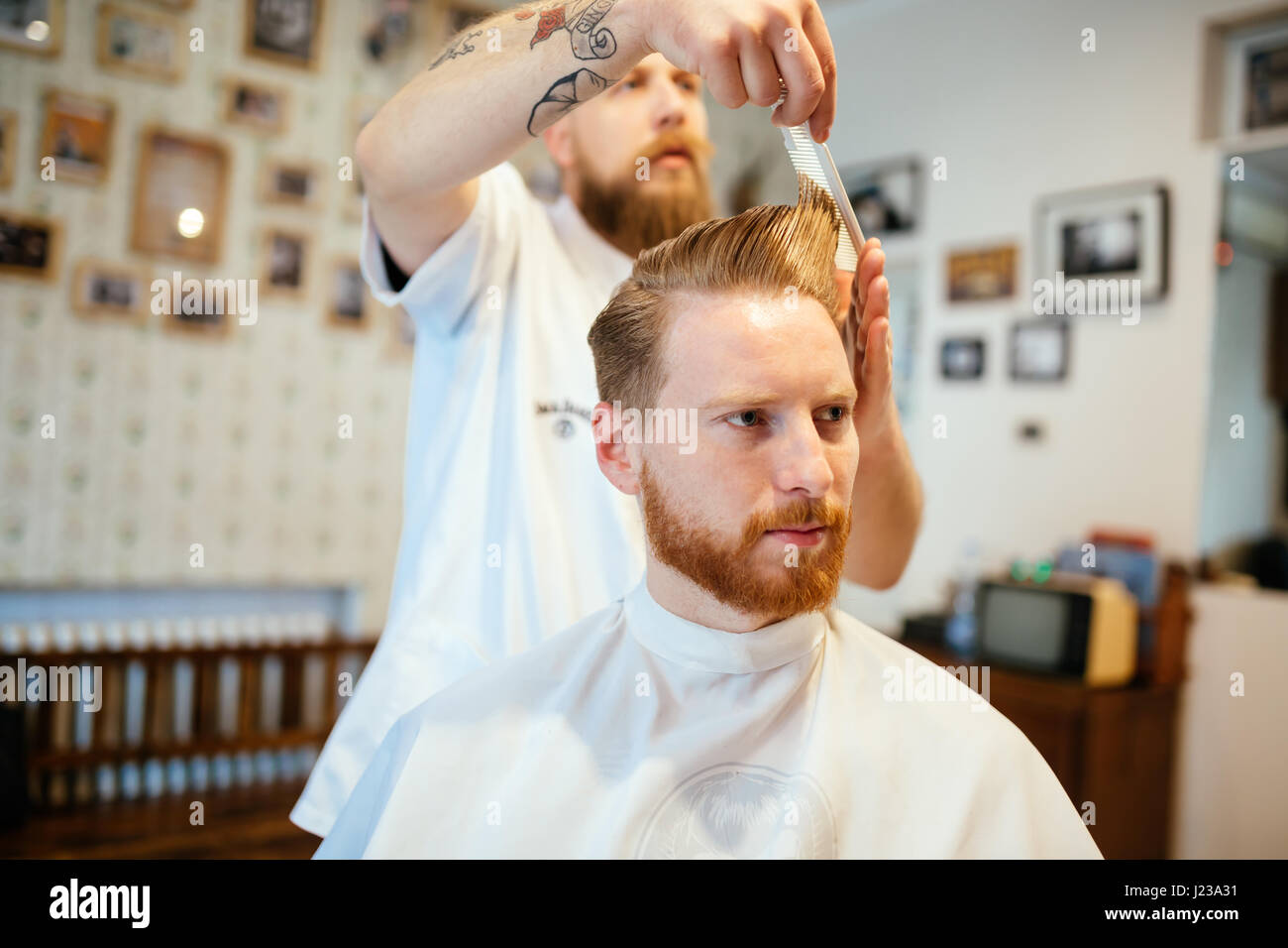 Combing of hair and styling in barber shop Stock Photo - Alamy