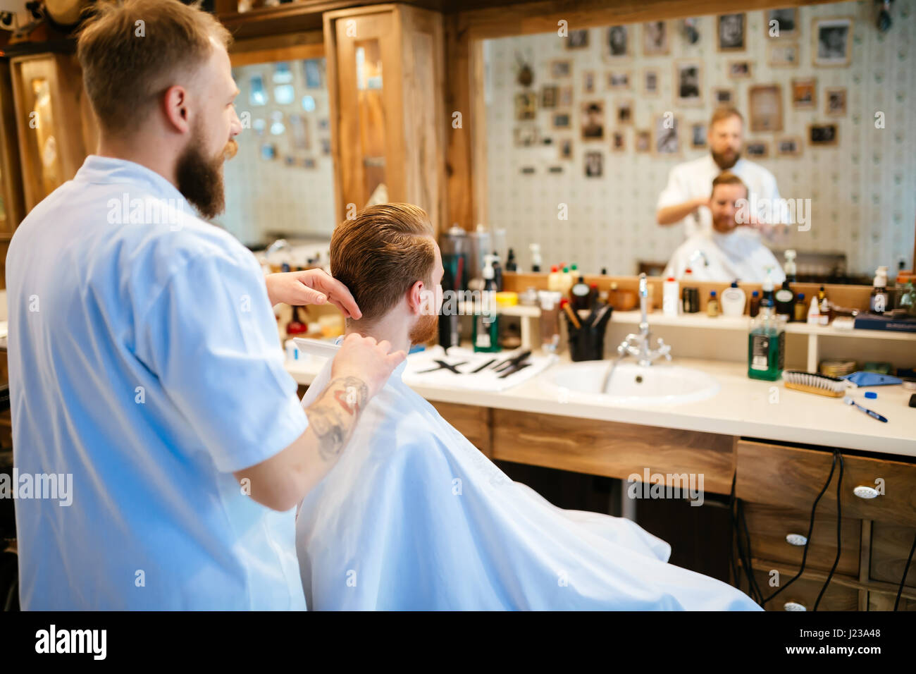 Combing of hair and styling in barber shop Stock Photo - Alamy