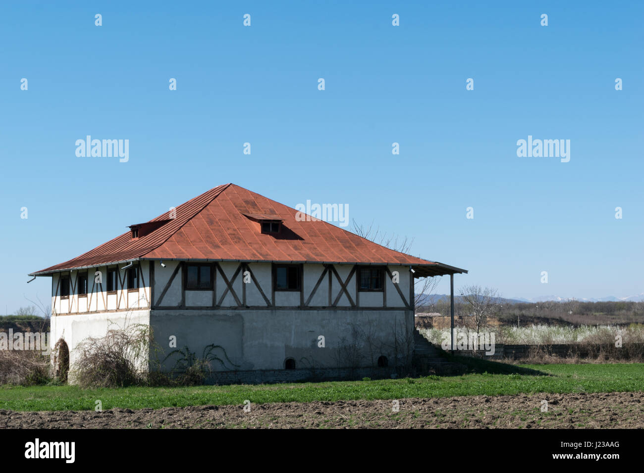 single plain house with interesting wood beams walls and hills in the ...