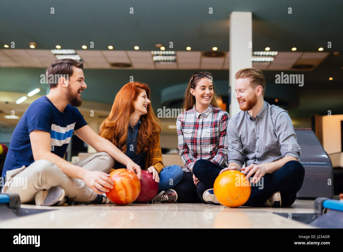 Cheerful friends bowling together and bonding Stock Photo - Alamy