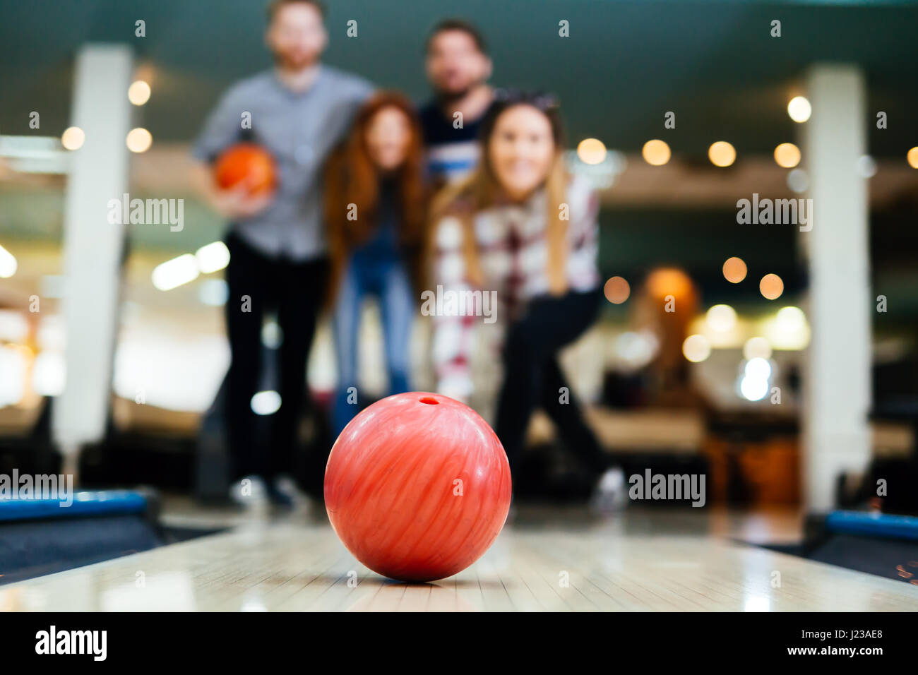 Friends bowling at club and having fun playing casually Stock Photo - Alamy