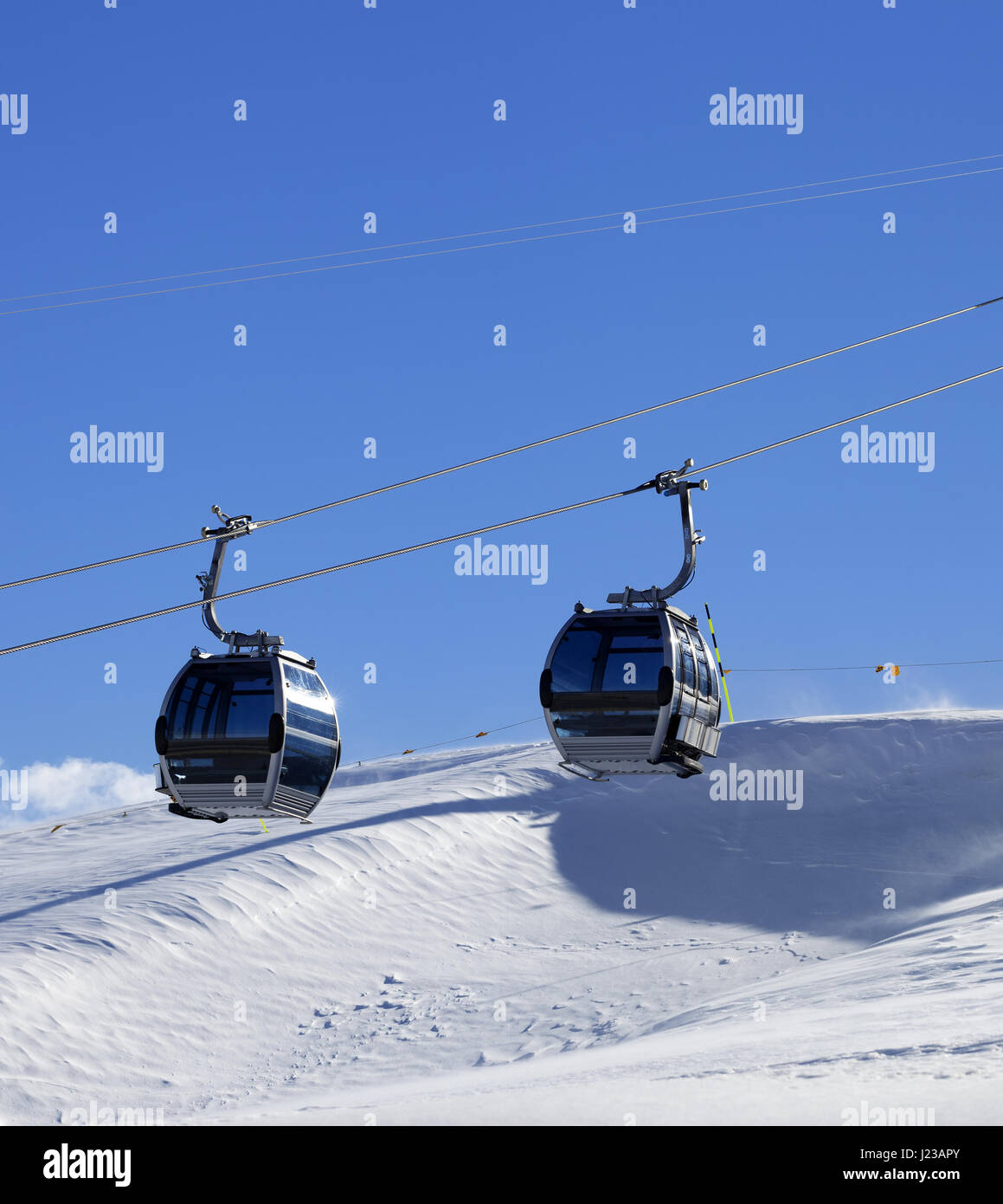 Gondola lift on ski resort at windy sun day. Greater Caucasus, Mount ...