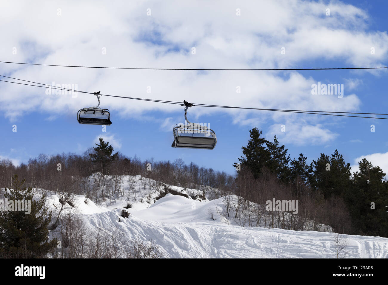 Chair-lift and off-piste slope in ski resort. Caucasus Mountains ...