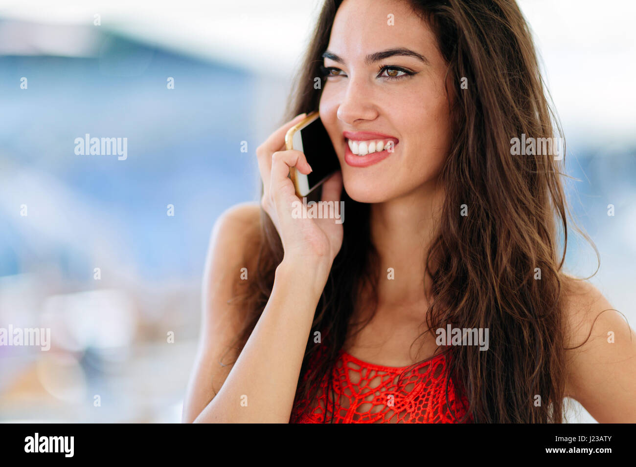 Beautiful model calling on phone and smiling Stock Photo - Alamy