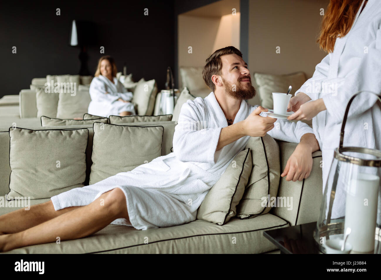 Handsome male in robe receiving his cup of tea Stock Photo - Alamy