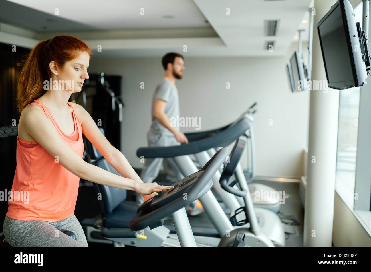 Sportive people cardio exercising in gym Stock Photo - Alamy