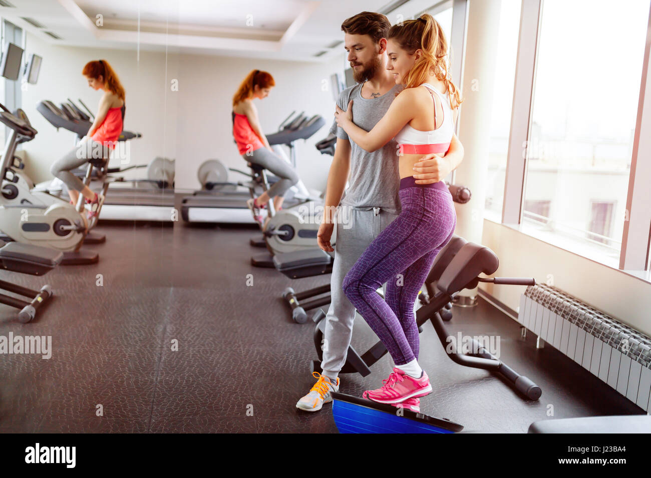 Attractive woman balance workout in gym Stock Photo - Alamy