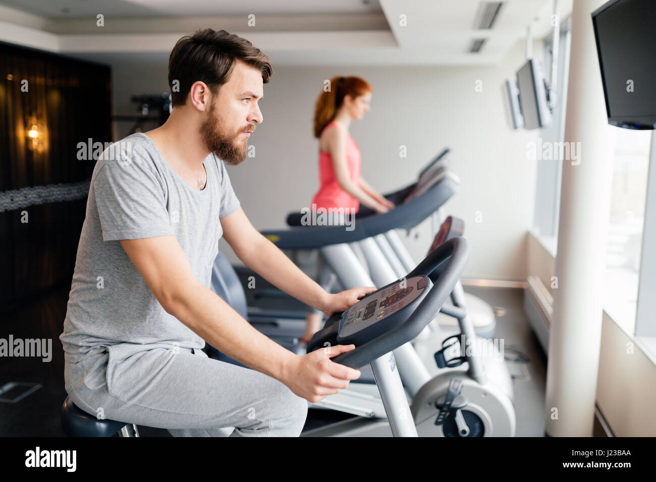 Sportive people cardio exercising in gym Stock Photo - Alamy