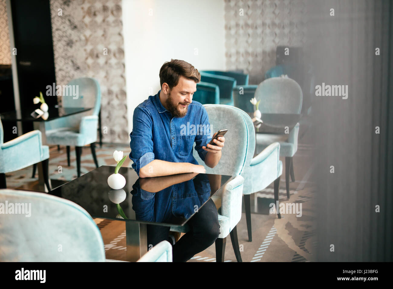 Handsome man waiting for date to arrive Stock Photo - Alamy