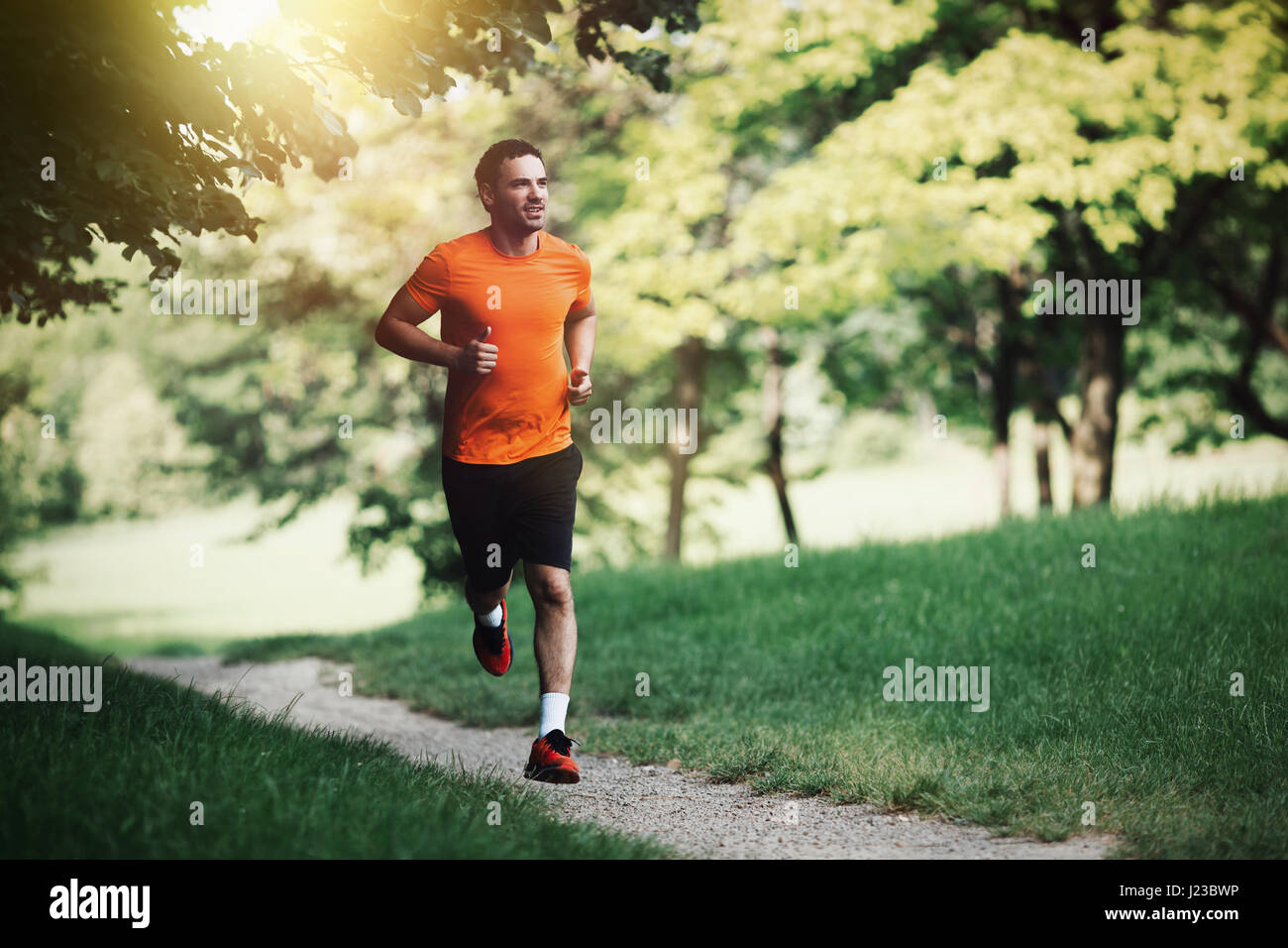 Active healthy runner jogging outdoor in nature Stock Photo - Alamy